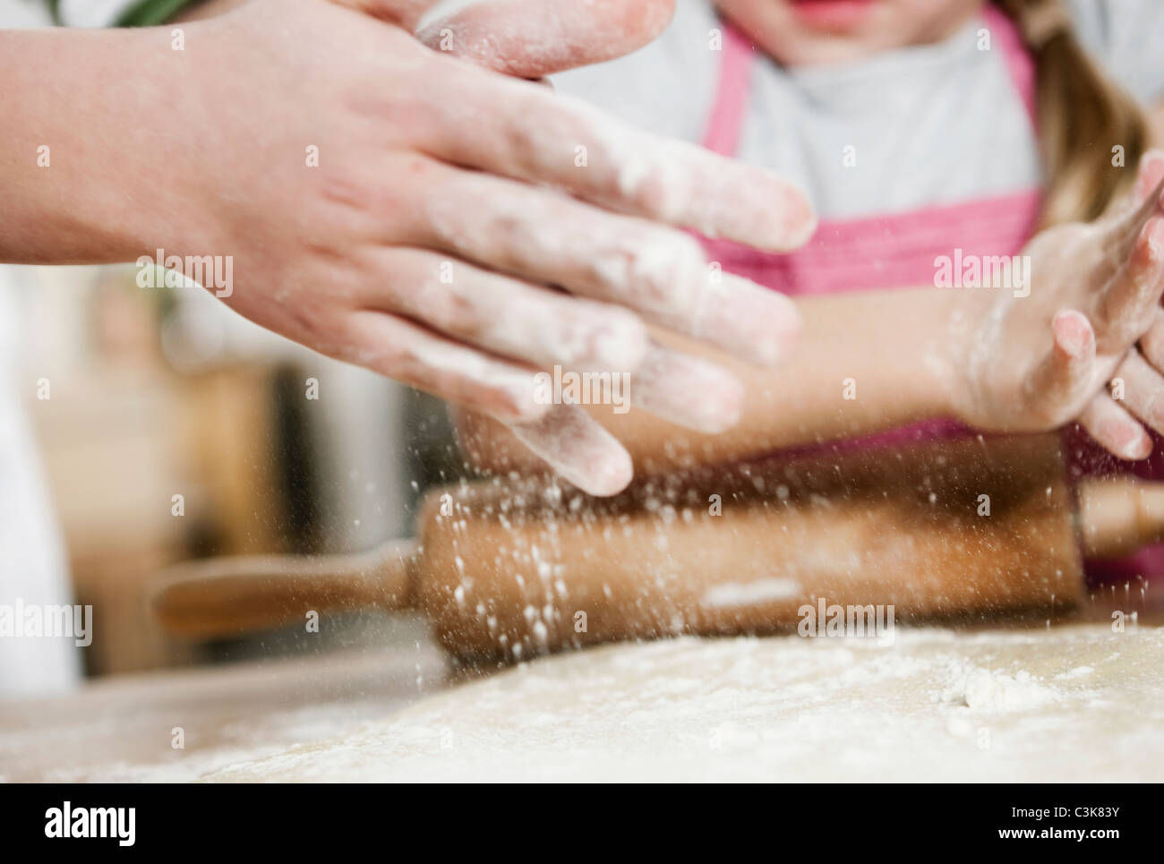 Germany, Cologne, Boy and girl rolling dough on kitchen worktop Stock ...
