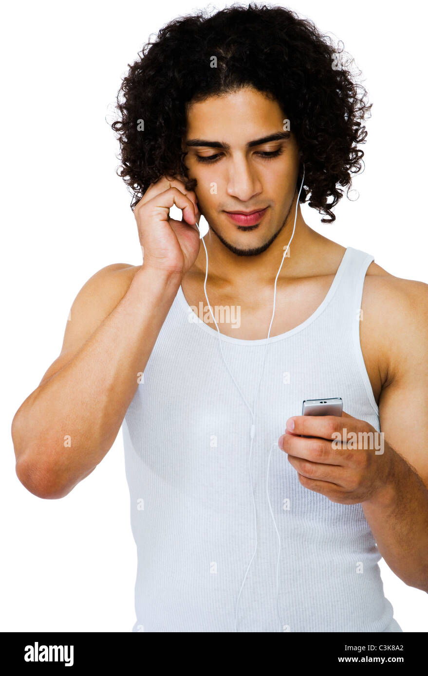 Latin American man listening to music on a MP3 player isolated over ...