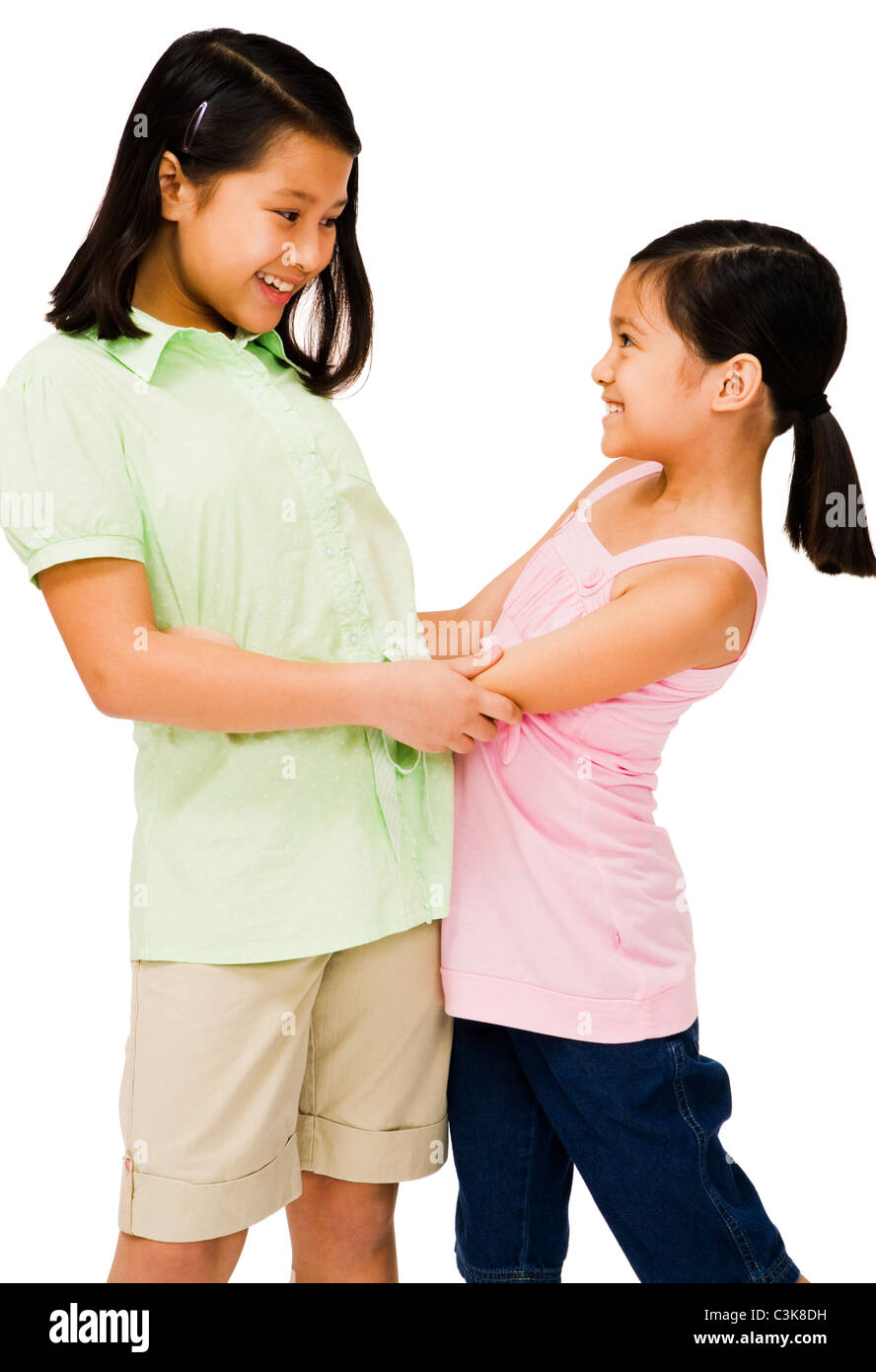 Cute girls hugging each other and smiling isolated over white Stock ...