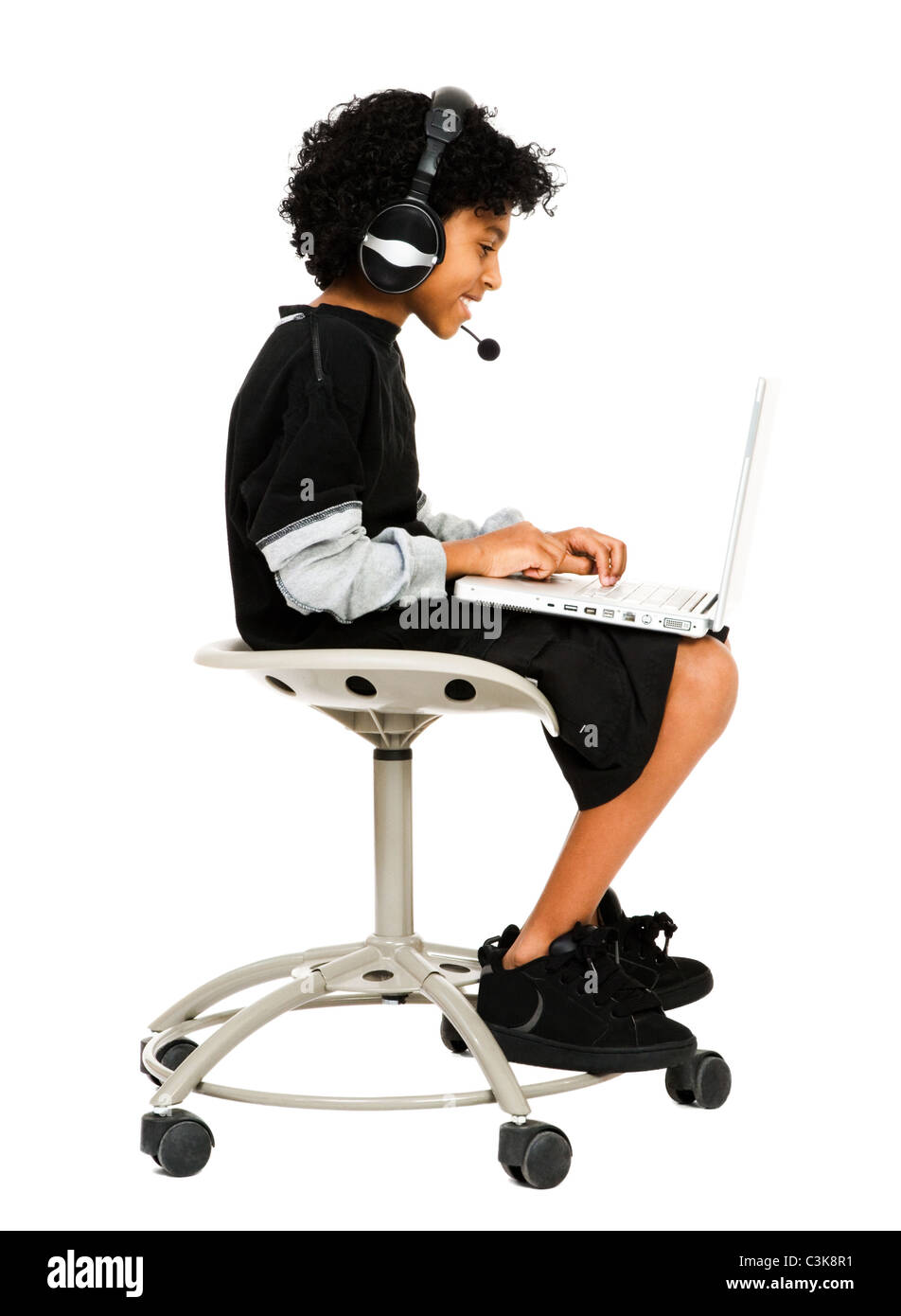 Happy boy using a laptop isolated over white Stock Photo - Alamy