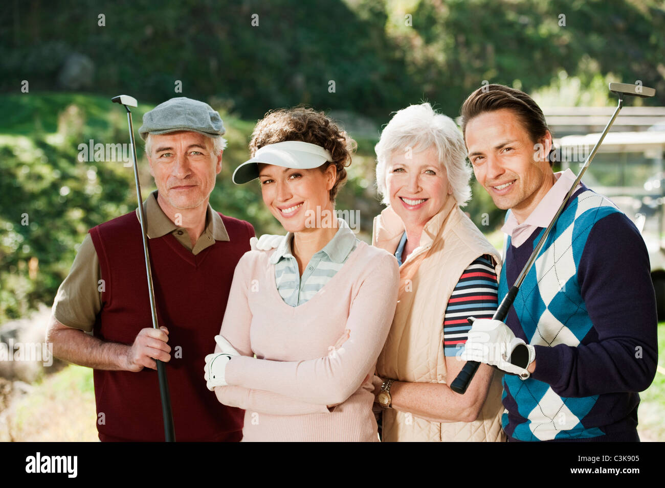 Italy, Kastelruth, Golfers on golf course, smiling, portrait Stock ...