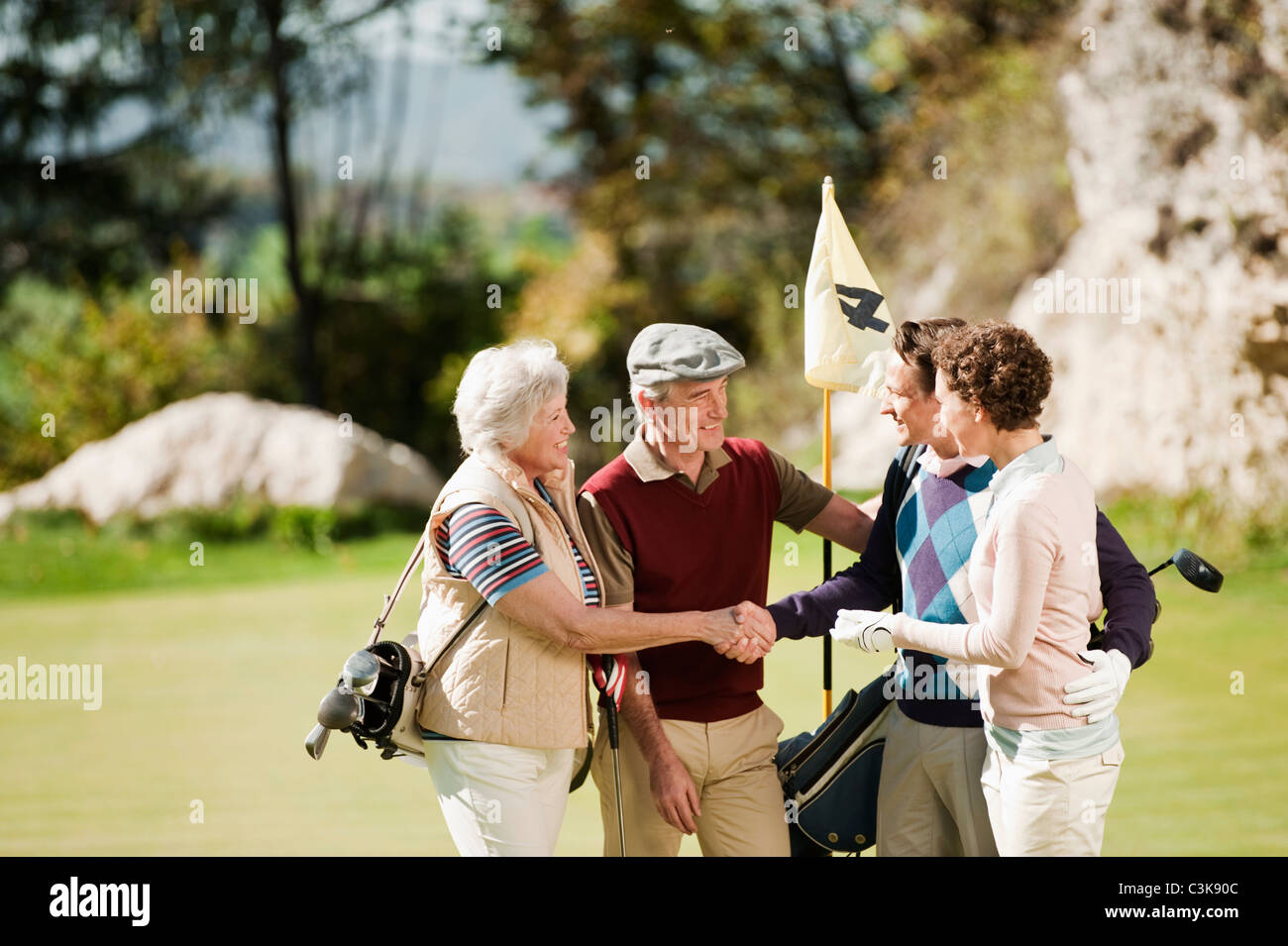 Italy, Kastelruth, Golfers talking on golf course Stock Photo - Alamy