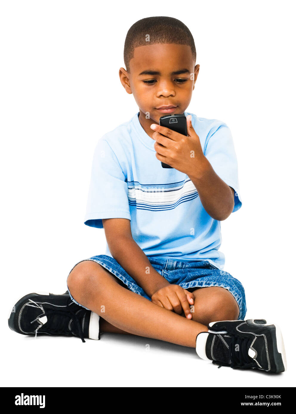 African boy text messaging on a mobile phone isolated over white Stock ...