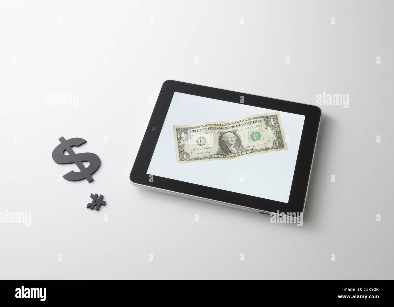 Tablet PC, bill, and currency signs Stock Photo - Alamy