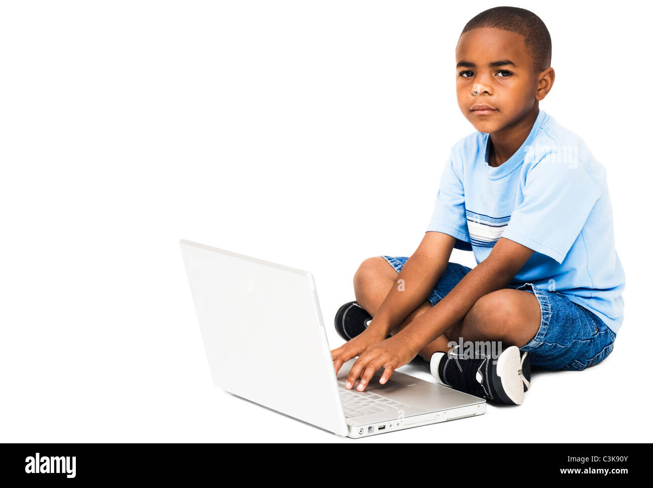 Portrait of a boy working on a laptop isolated over white Stock Photo ...