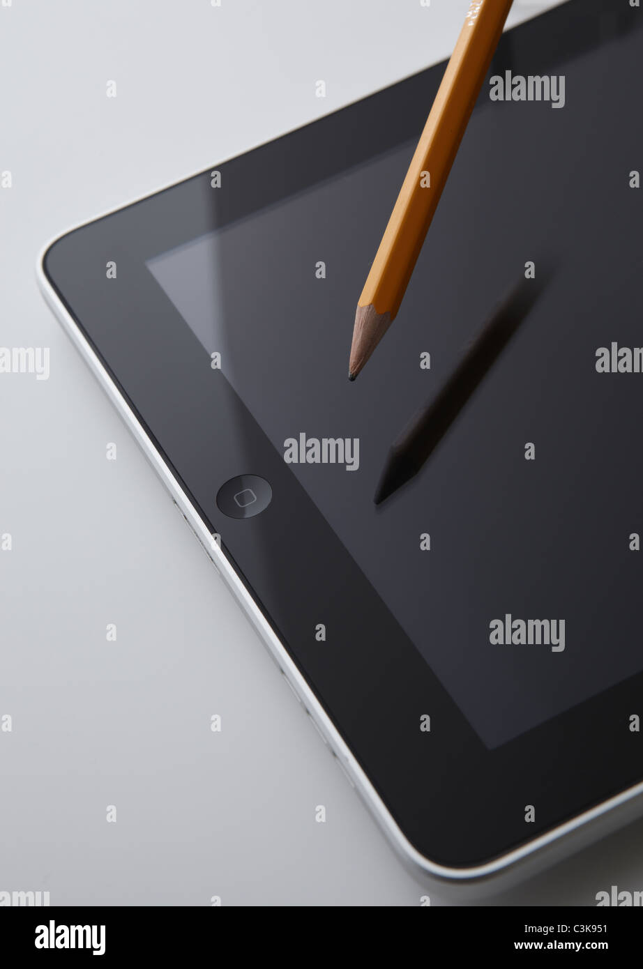 Tablet PC and pencil Stock Photo - Alamy