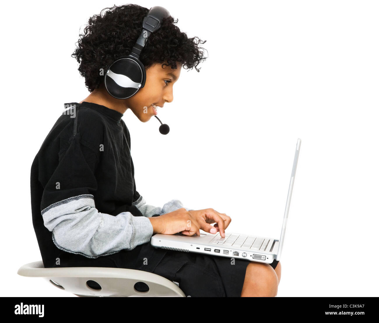 Boy surfing the net and smiling isolated over white Stock Photo - Alamy