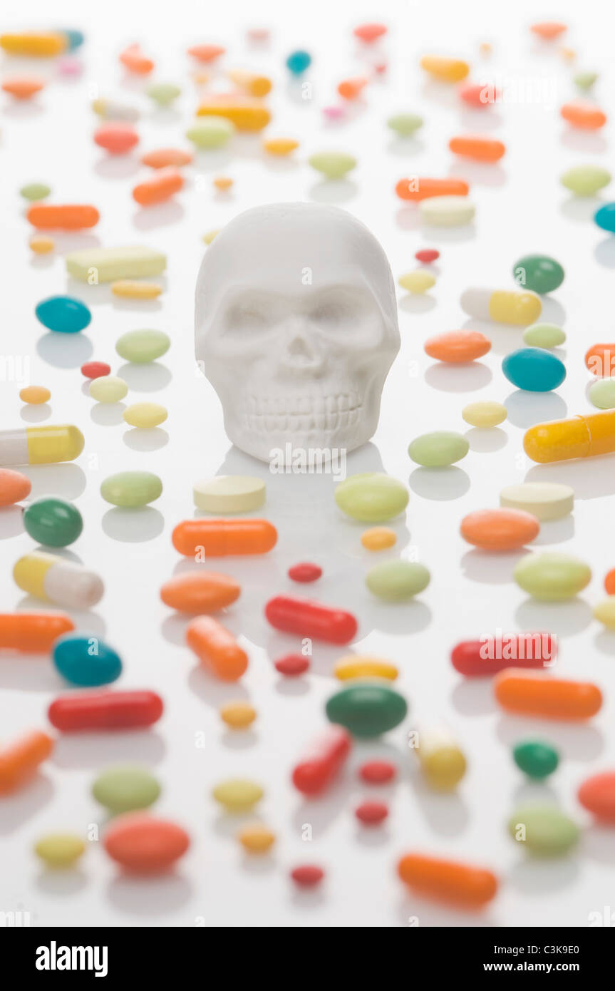 Skull, pills and drugs on white background Stock Photo - Alamy