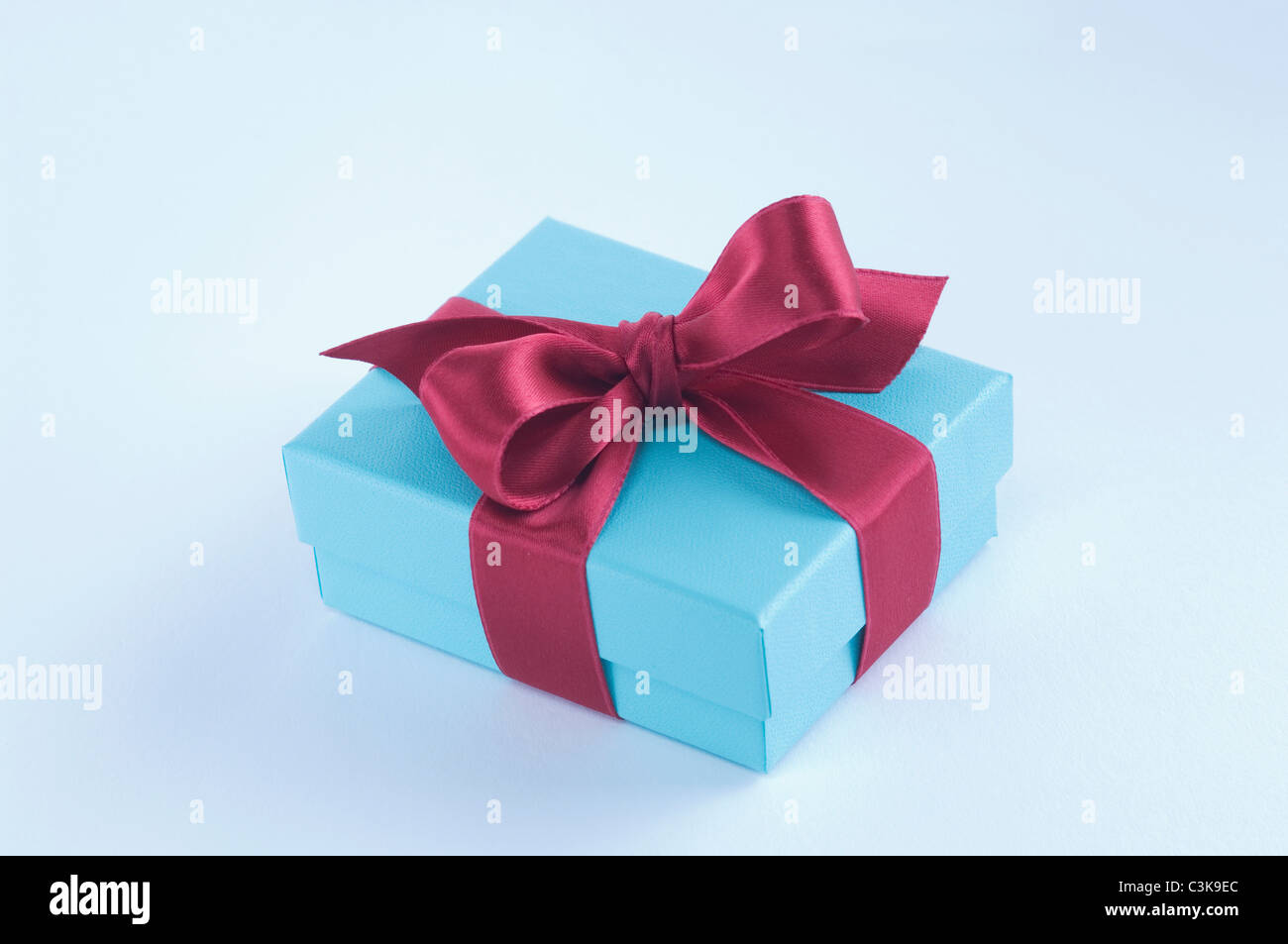 Gift box tied with red ribbon Stock Photo - Alamy