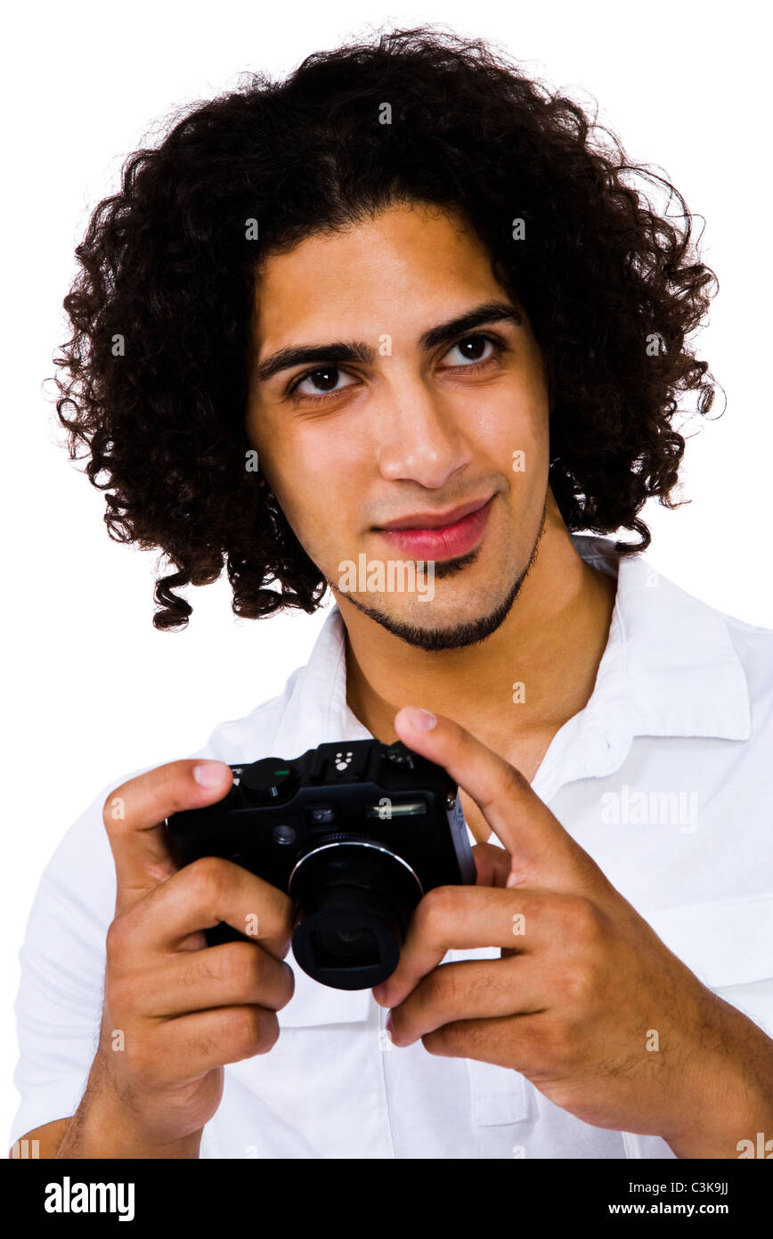 Fashion model photographing with a camera and smiling isolated over ...