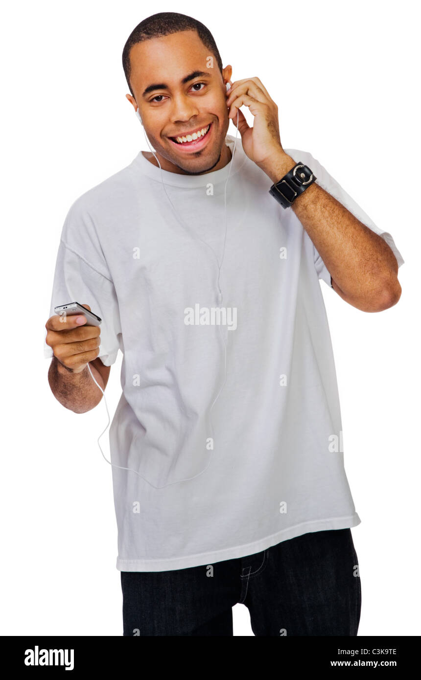 Portrait of a man listening to music on a MP3 player isolated over ...