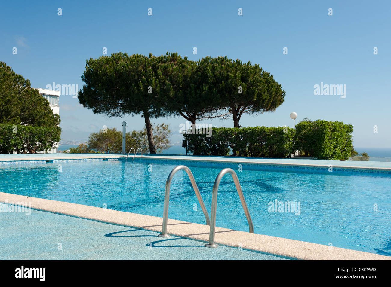 Large rectangular swimming pool against the background of the ocean ...