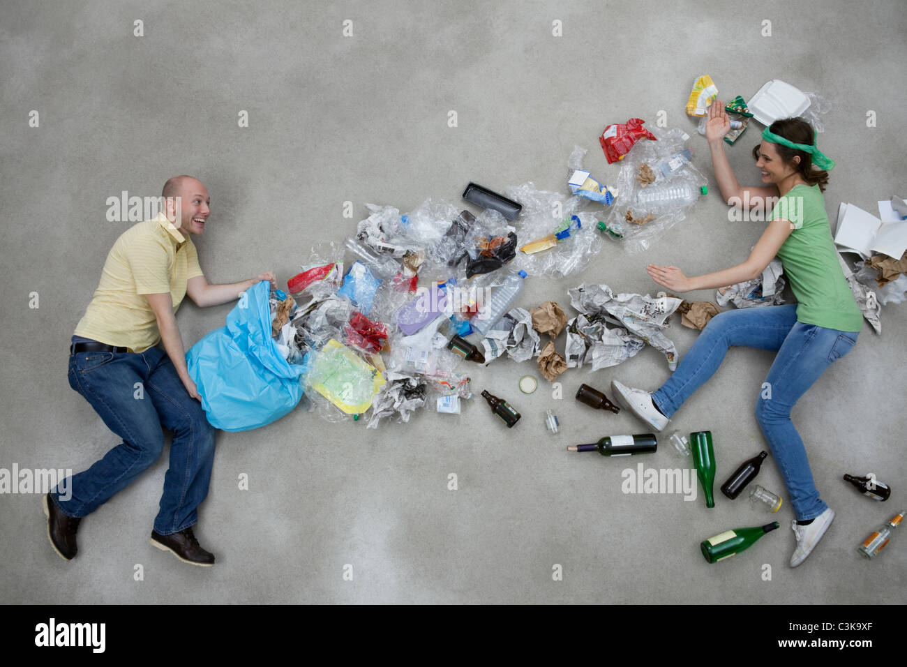 Man throwing garbage towards woman Stock Photo - Alamy