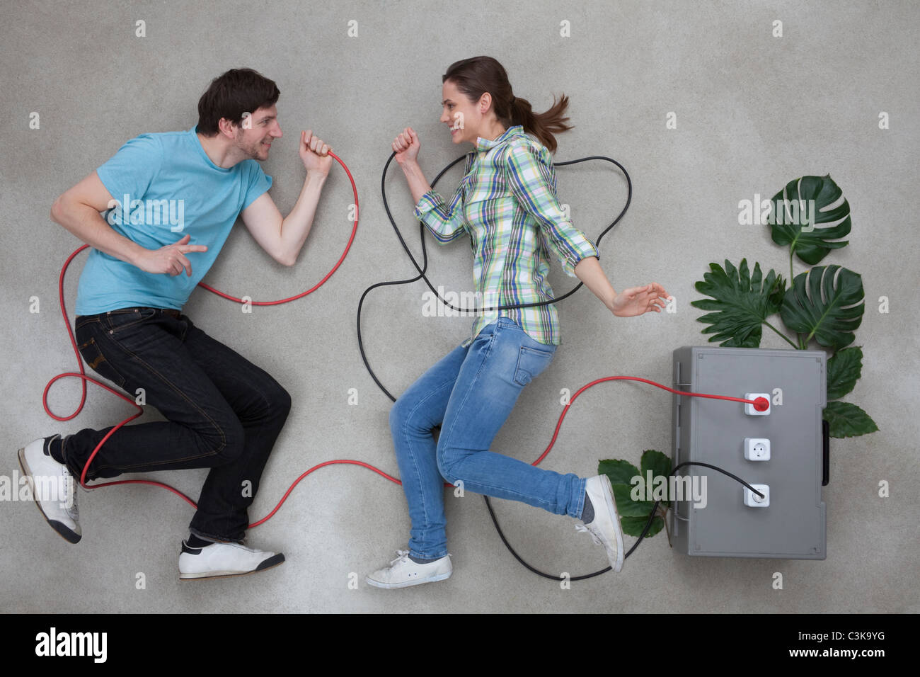 Man and woman holding cable wire and looking at eachother, smiling ...