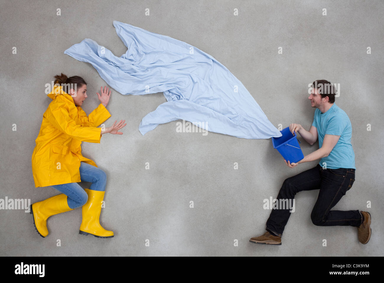 Man splashing bucket of water on woman Stock Photo - Alamy