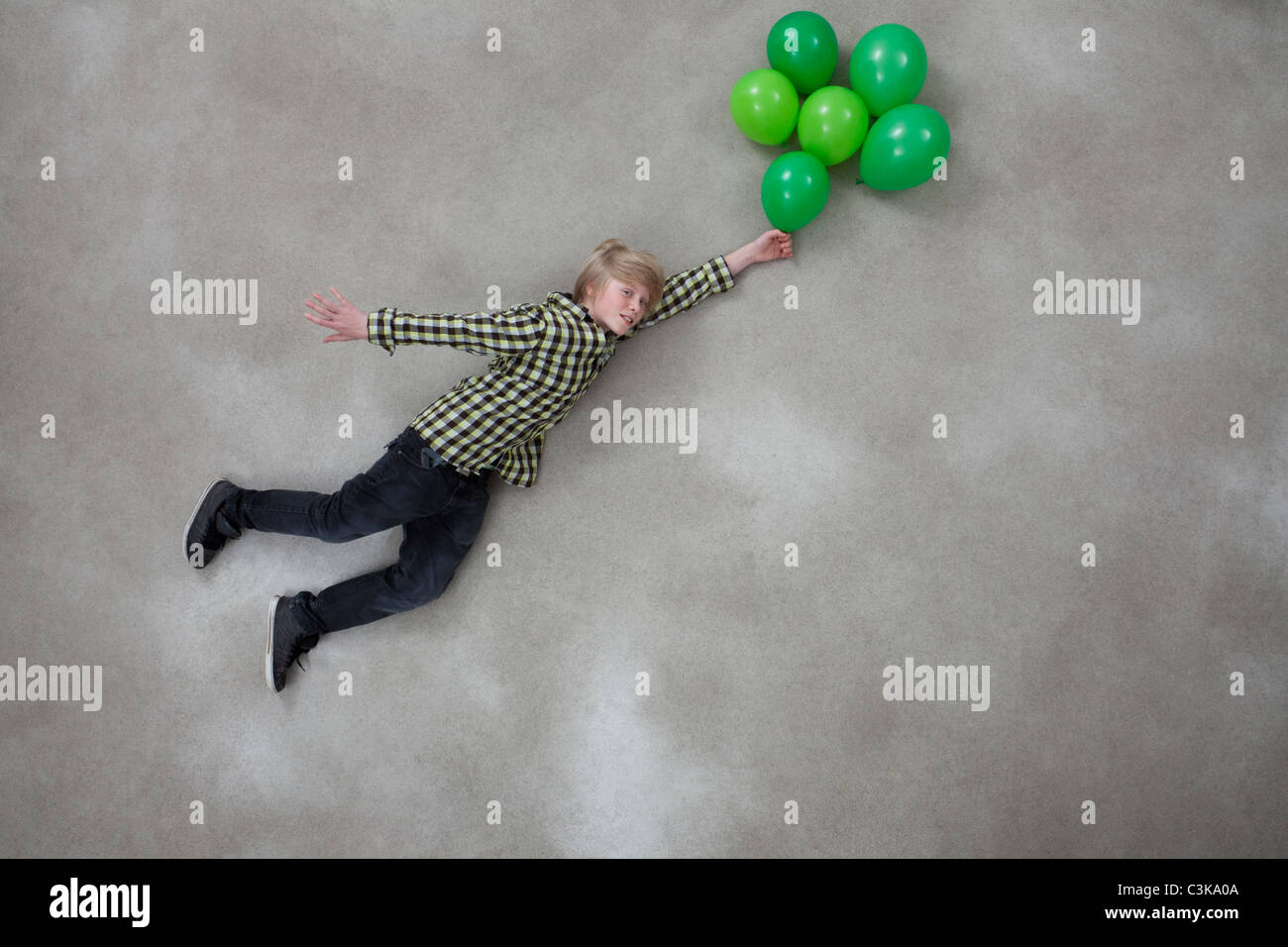 Boy flying balloons hi-res stock photography and images - Alamy