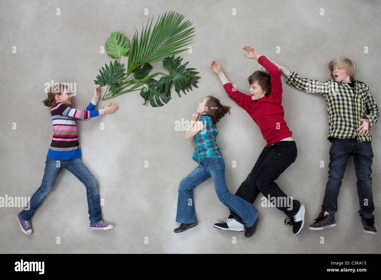 Children with plant and showing ecology symbol Stock Photo - Alamy