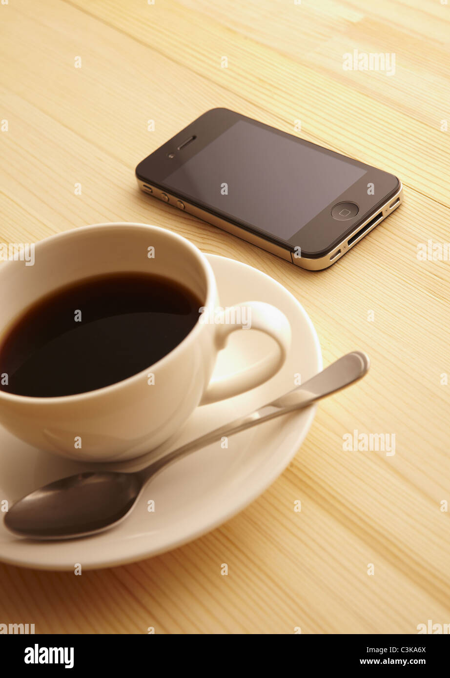 Smartphone and hot coffee Stock Photo - Alamy