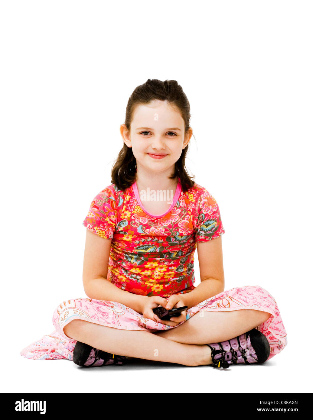 Happy girl text messaging on a mobile phone isolated over white Stock ...