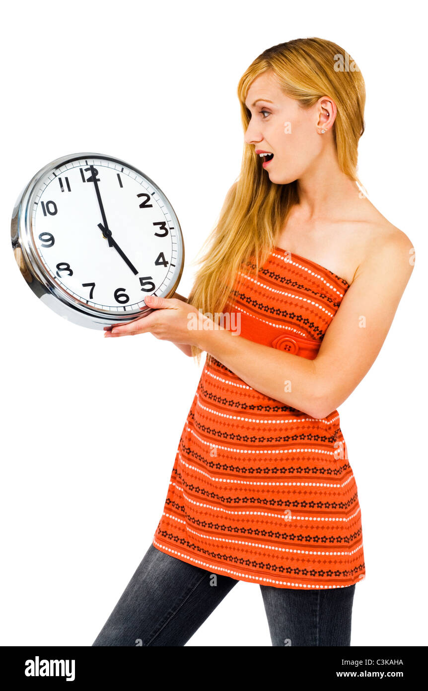 Surprised young woman holding a clock isolated over white Stock Photo ...