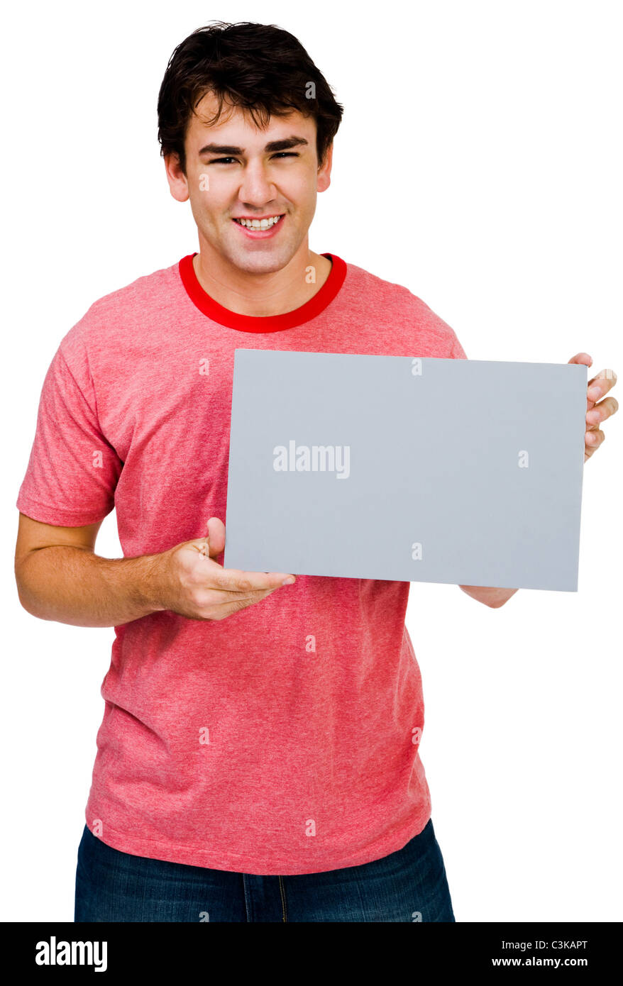 Handsome man showing a placard and smiling isolated over white Stock ...