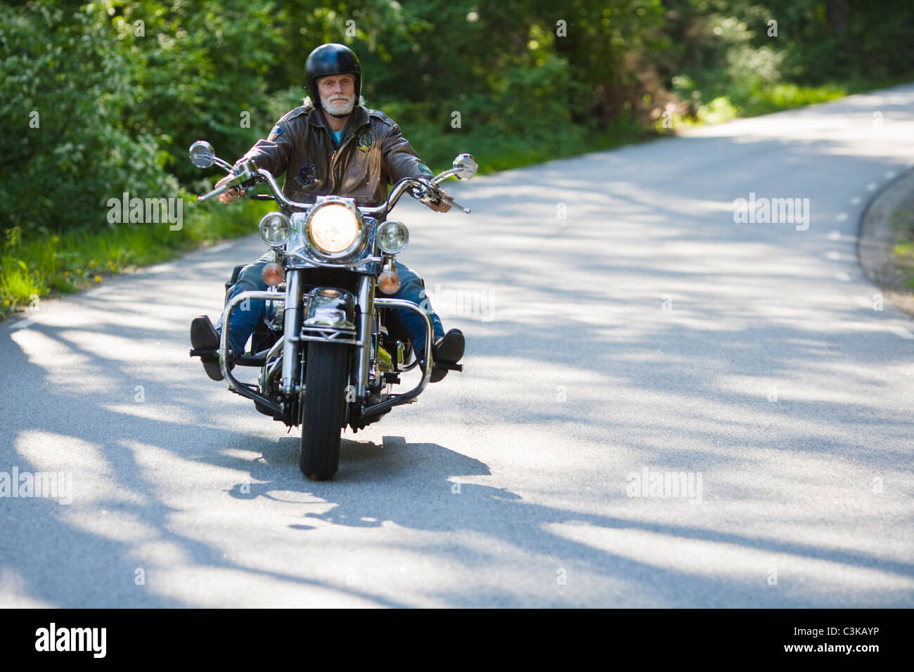Senior man riding vintage motorbike Stock Photo - Alamy