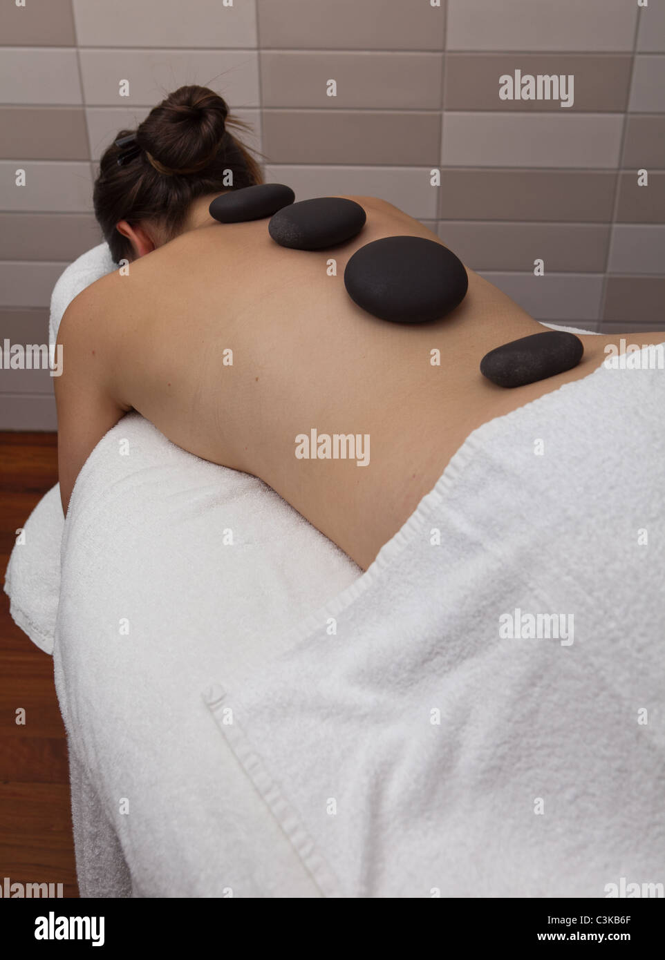 Hot stone therapy massage Stock Photo - Alamy