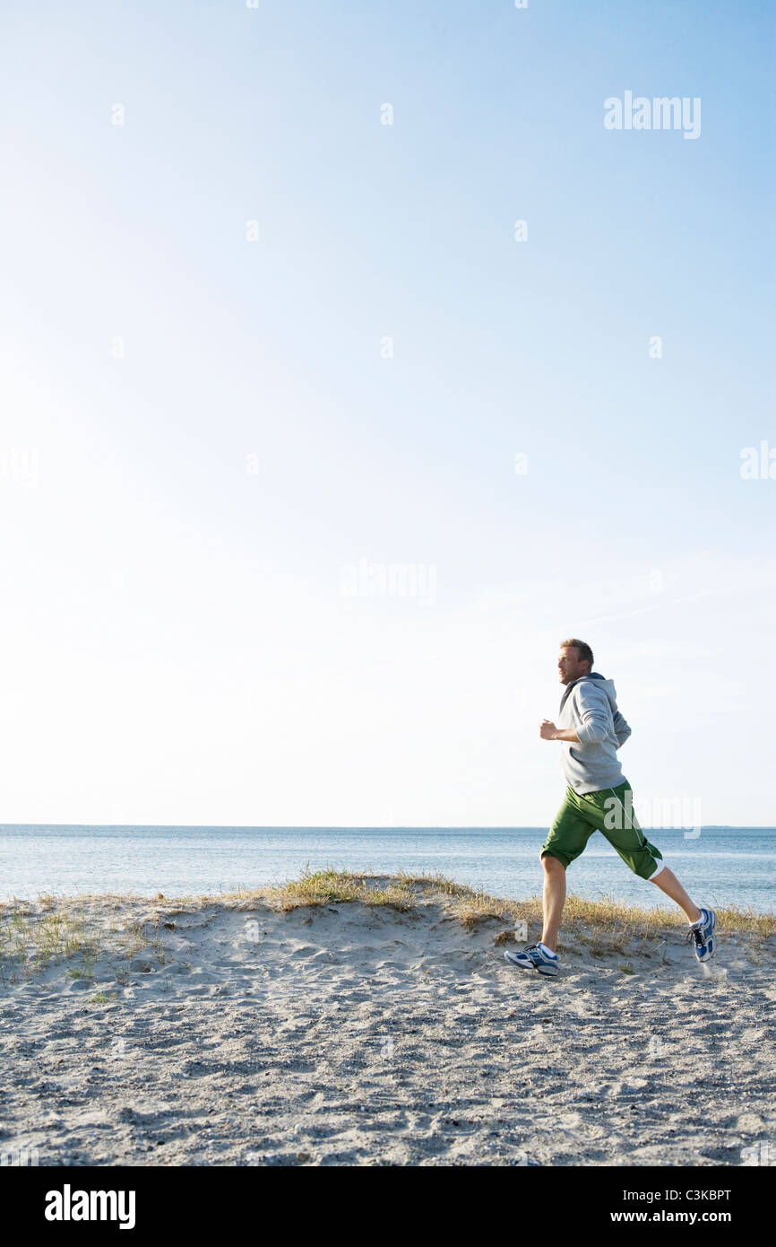 A man jogging on the beach, Malmo, Sweden Stock Photo - Alamy