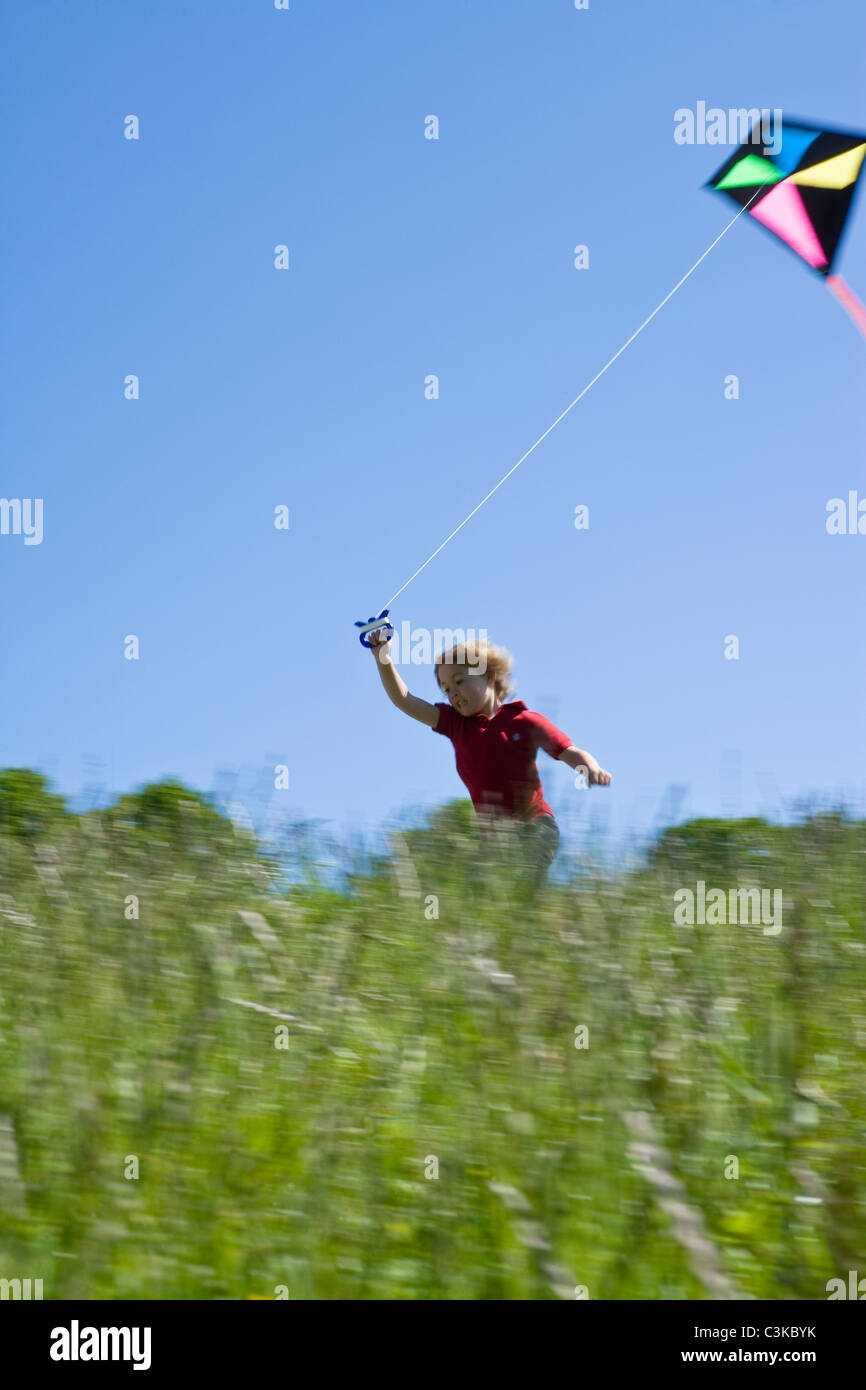 Boy running with kite Stock Photo - Alamy