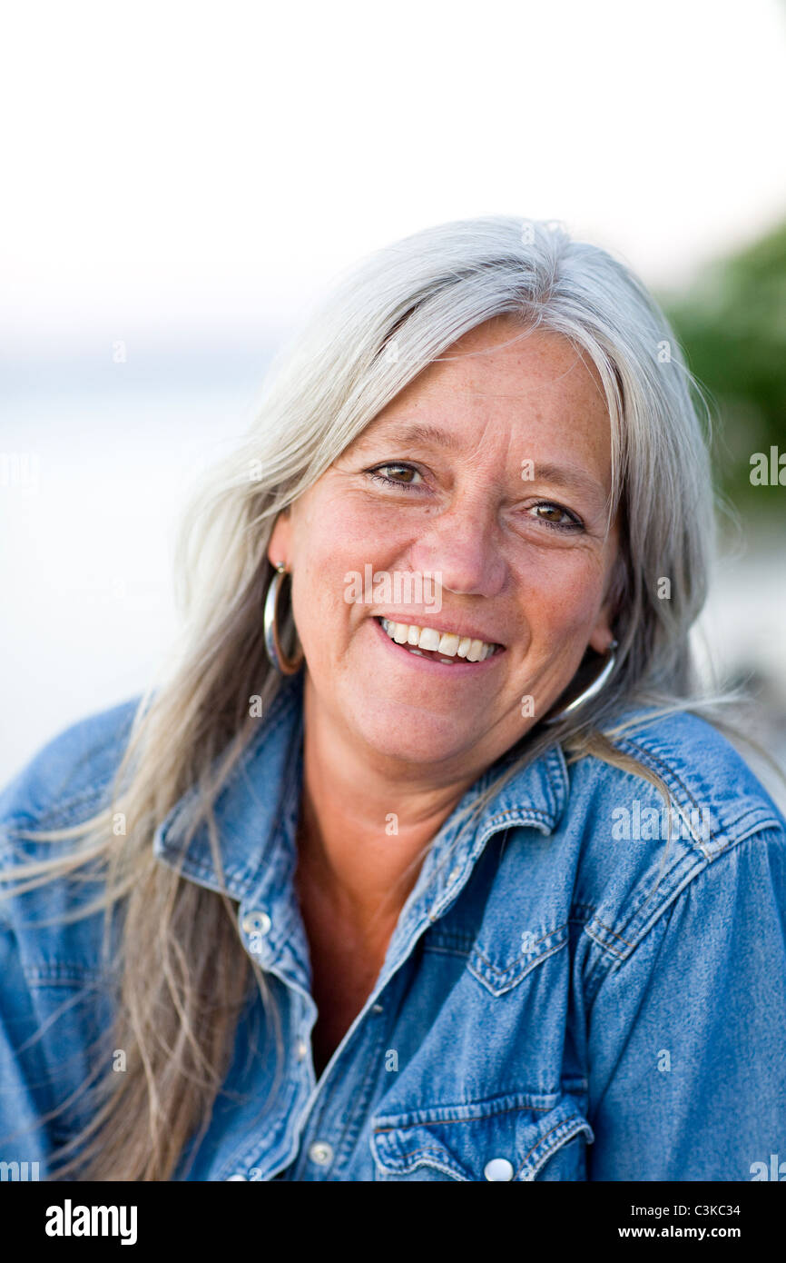 Mature woman smiling to camera Stock Photo - Alamy