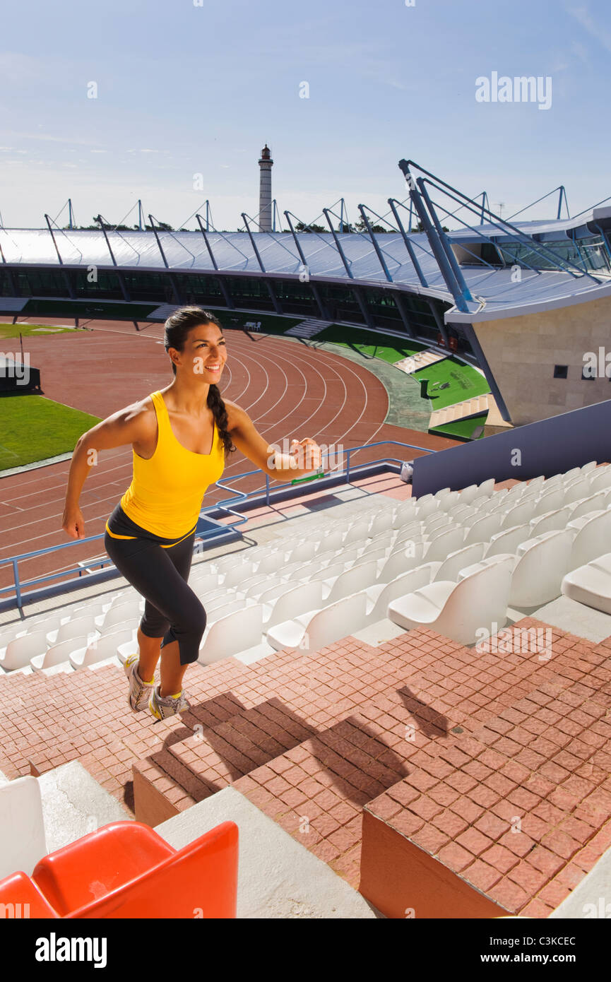 Female athlete running up stadium steps Stock Photo - Alamy