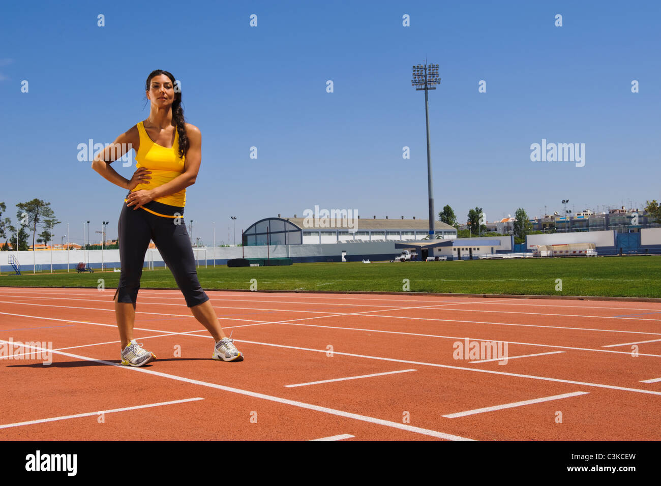 Female athlete standing at stadium Stock Photo - Alamy
