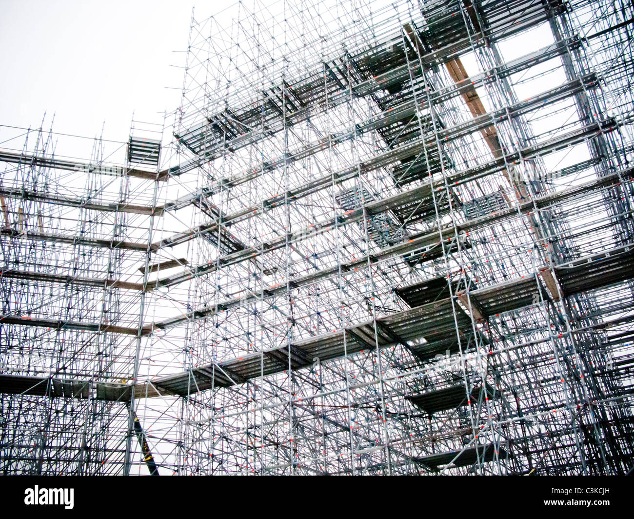 Building with scaffolding at construction site Stock Photo - Alamy