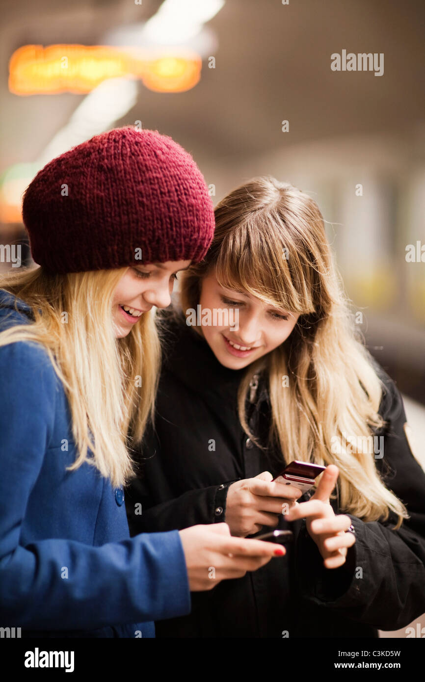 Two teenage girls using cell phones Stock Photo - Alamy