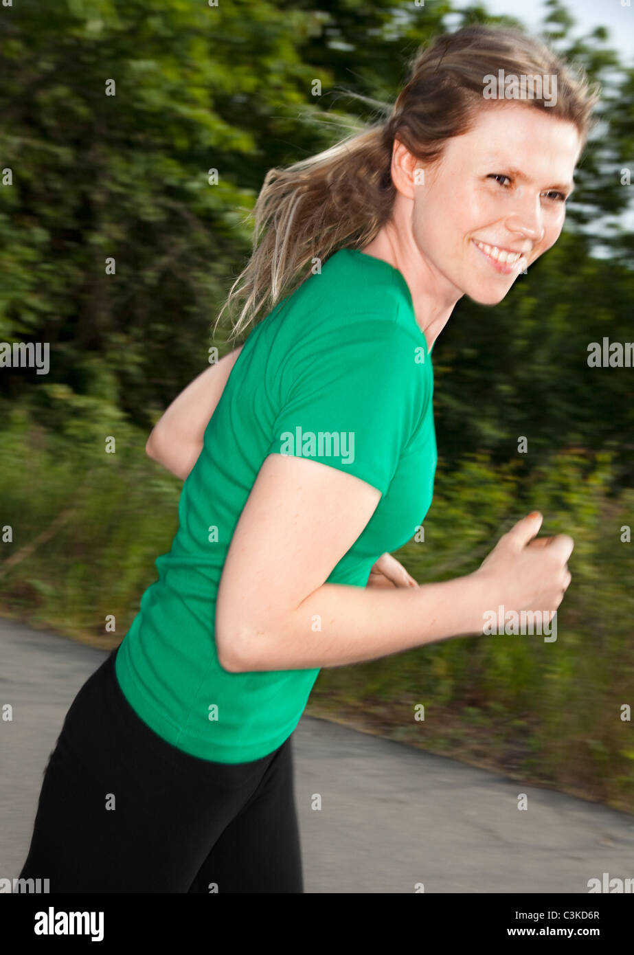 Young woman jogging Stock Photo - Alamy