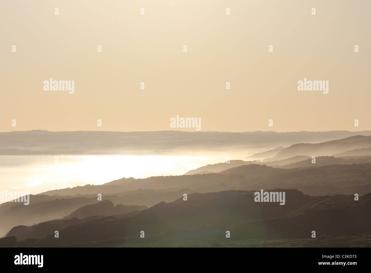 Mist over dunes at sunset Stock Photo - Alamy
