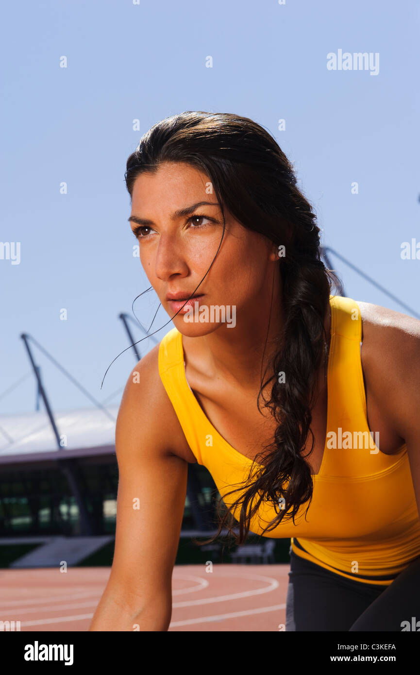 Female athlete sprinting at stadium Stock Photo - Alamy