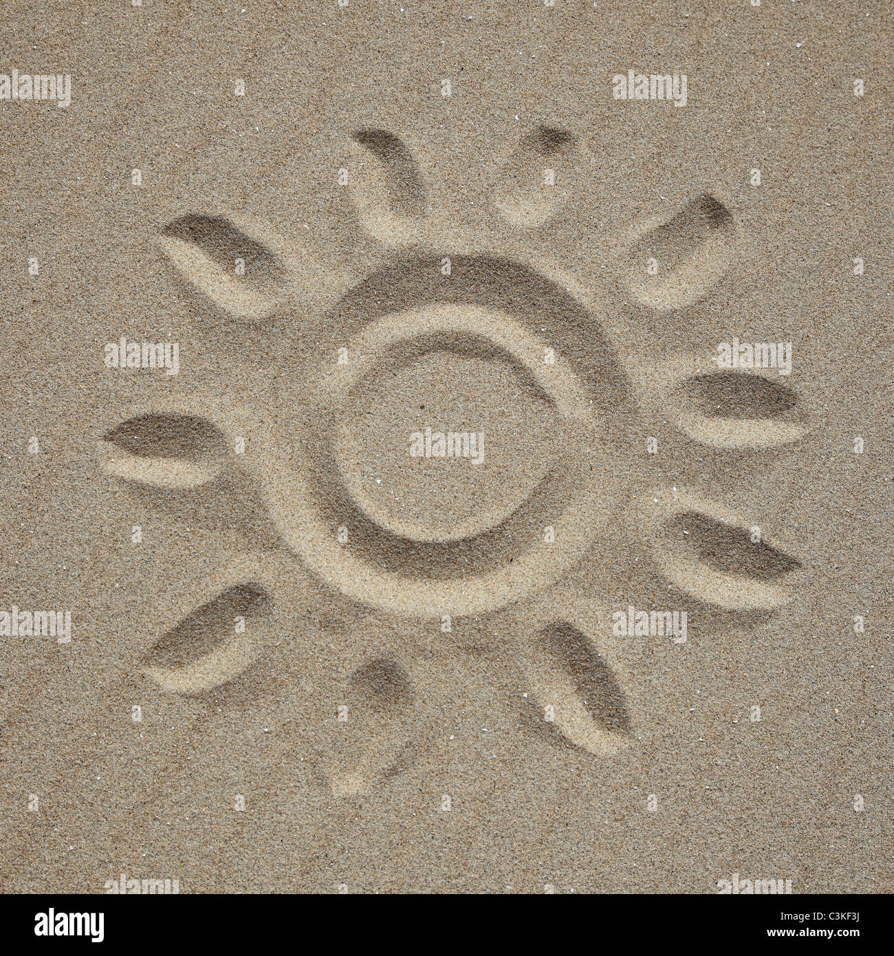 The sun drawn into the sand Stock Photo - Alamy