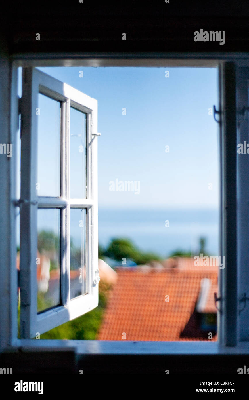 View of rooftop of house through open window Stock Photo - Alamy