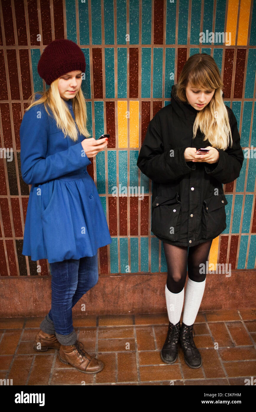 Two teenage girls using cell phones Stock Photo - Alamy