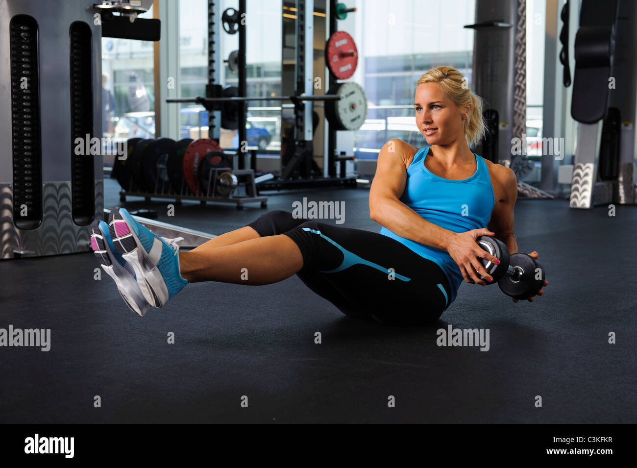 Woman exercising in gym Stock Photo - Alamy