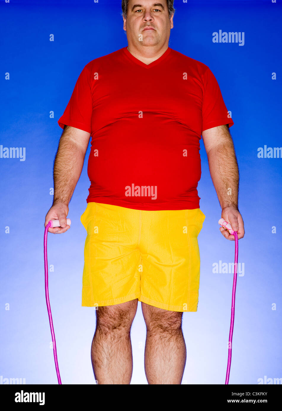Obese man holding skipping rope, portrait Stock Photo - Alamy