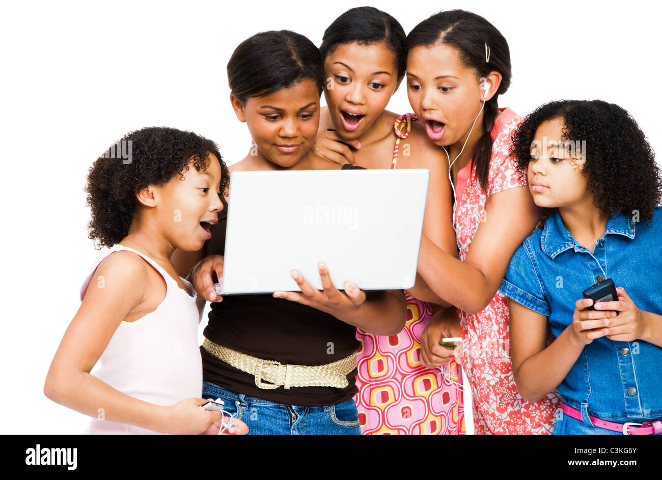 Shocked friends using a laptop isolated over white Stock Photo - Alamy