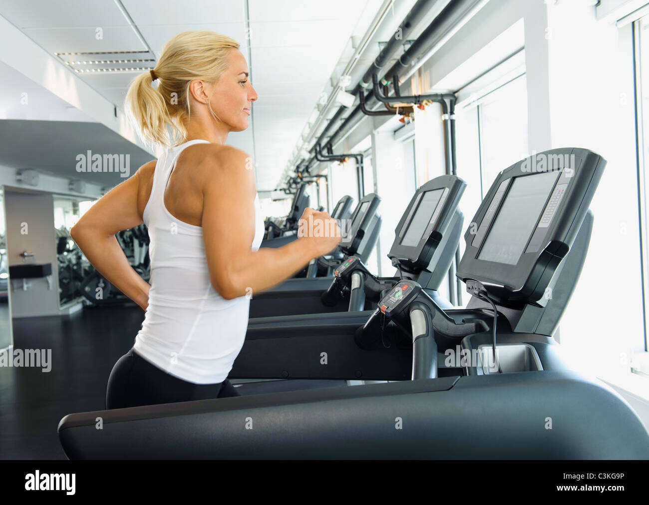 Woman exercising on treadmill in gym Stock Photo - Alamy