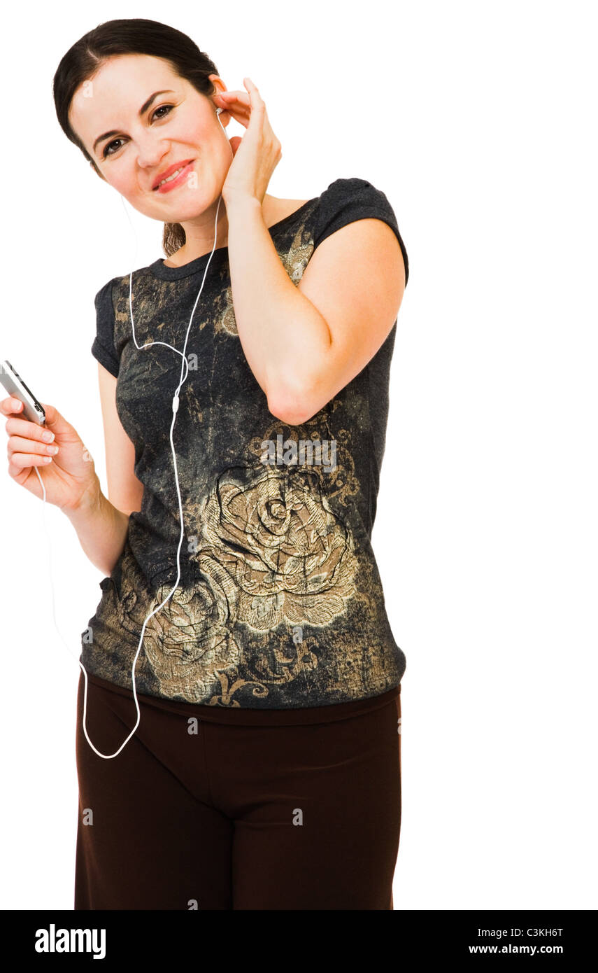 Fashion model listening to music on MP3 player isolated over white ...
