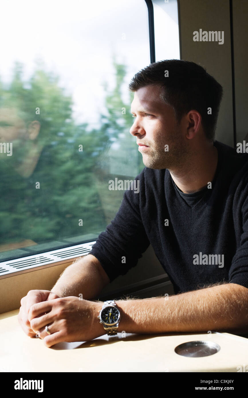 Man sitting in train Stock Photo - Alamy