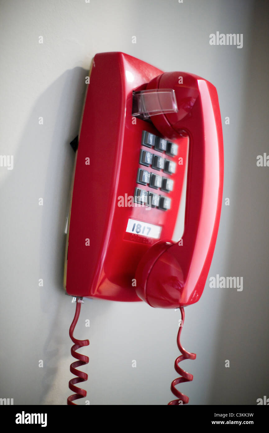Red telephone on hotel wall Stock Photo - Alamy