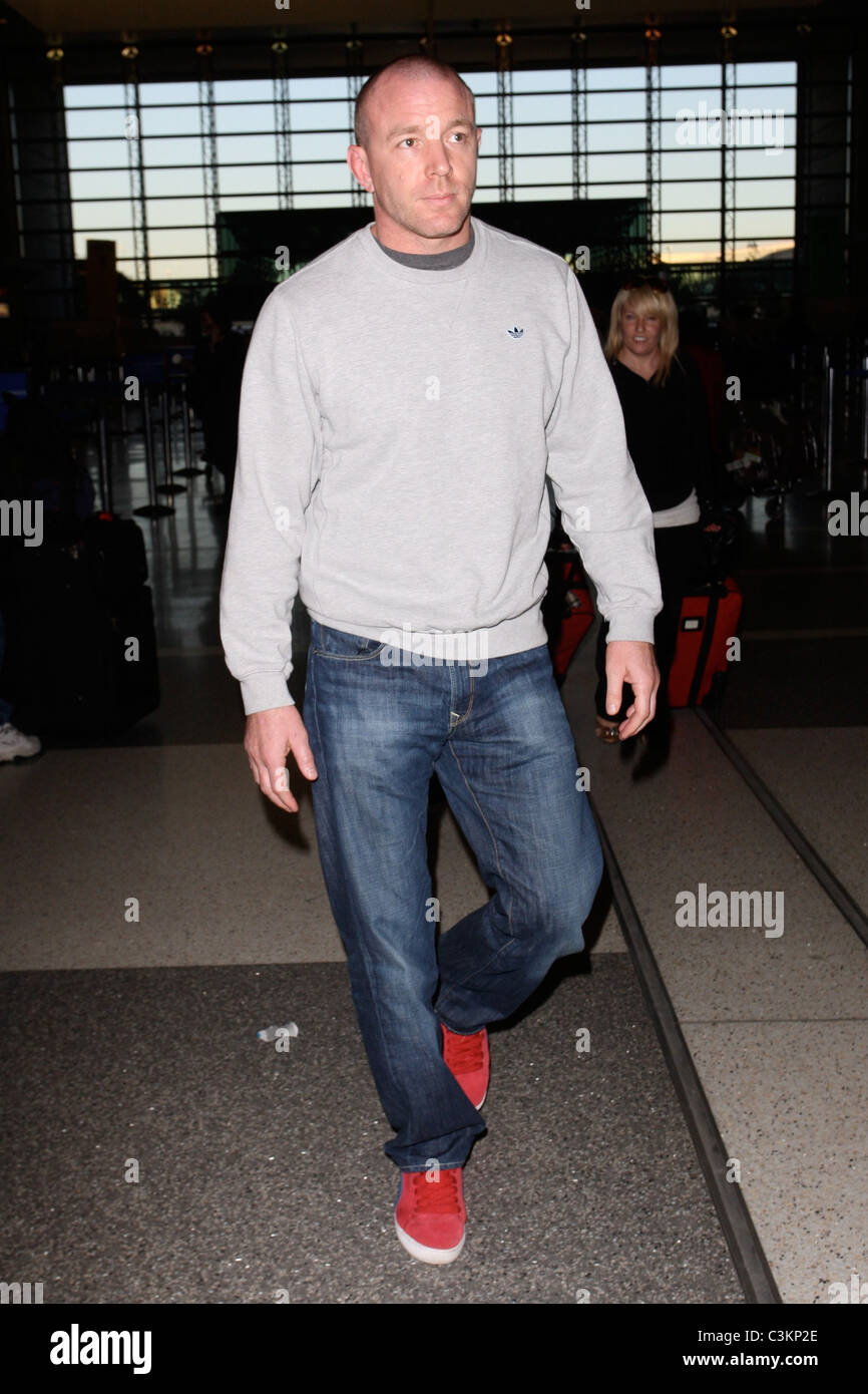 Sherlock Holmes' director Guy Ritchie arriving at LAX airport to catch ...
