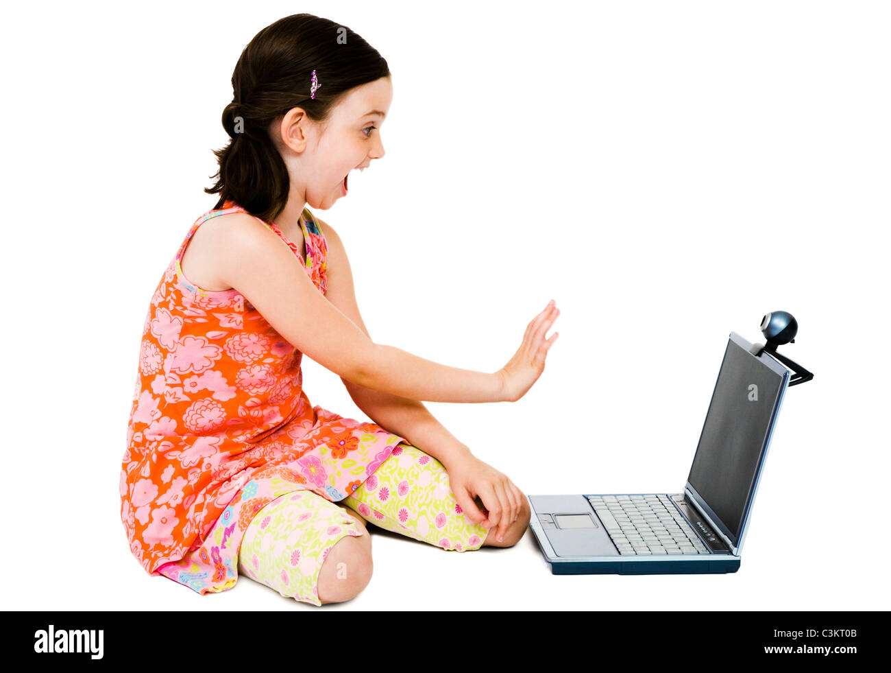 Happy girl using a laptop and posing isolated over white Stock Photo ...