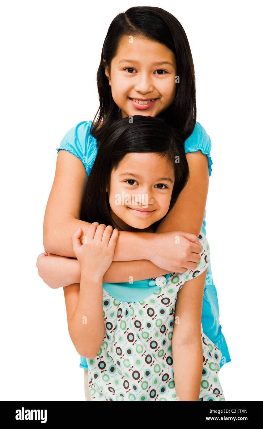 Two girls hugging each other and smiling isolated over white Stock ...